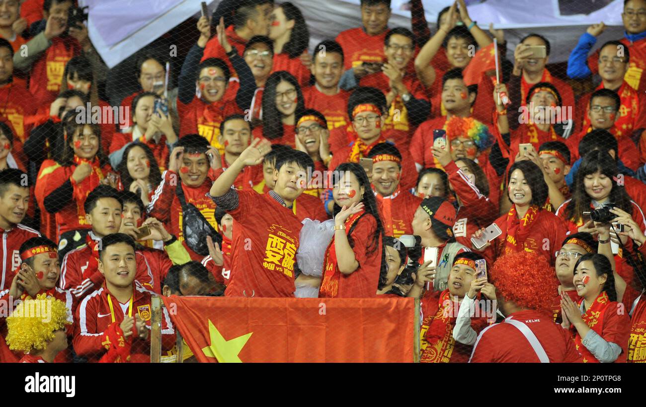 Chinese football fans shout slogans to show support for the Chinese ...