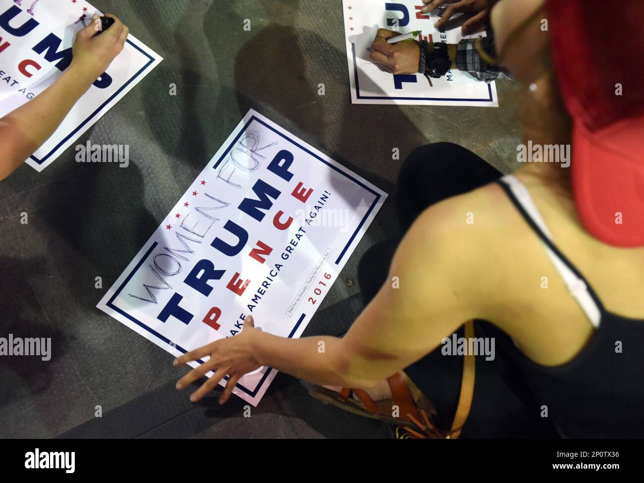 Ashley DiFulvio writes on her sign during before the rally for Donald ...