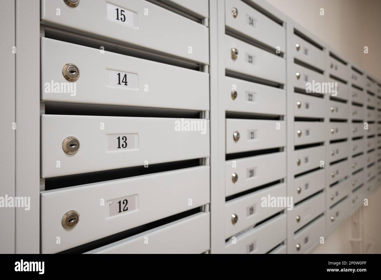 A row of new empty mailboxes with numbers of apartments Stock Photo - Alamy