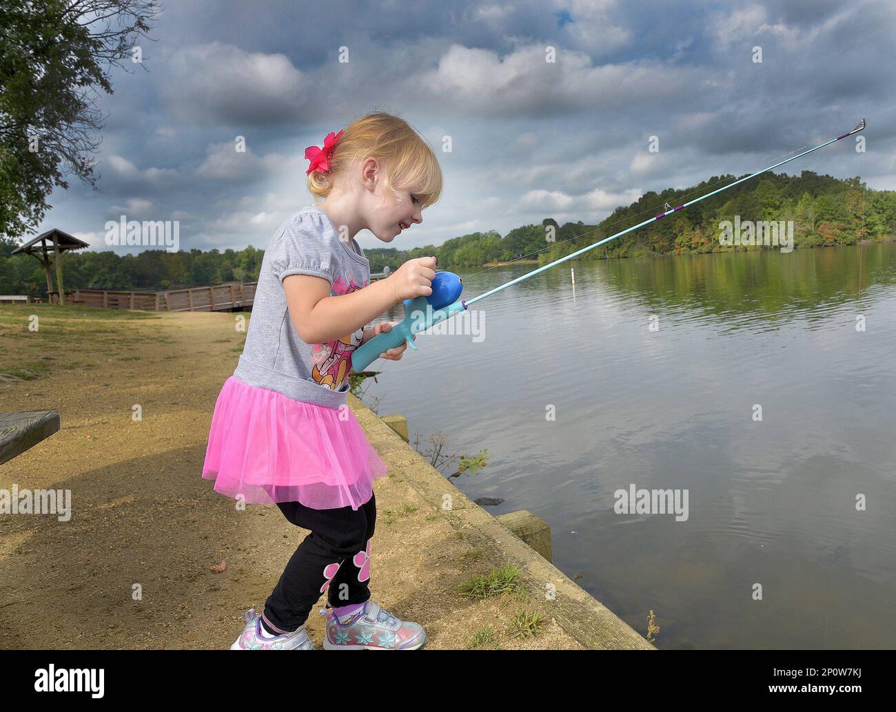 Three-year-old Ella Hagy tries out her fishing pole hoping to catch a ...