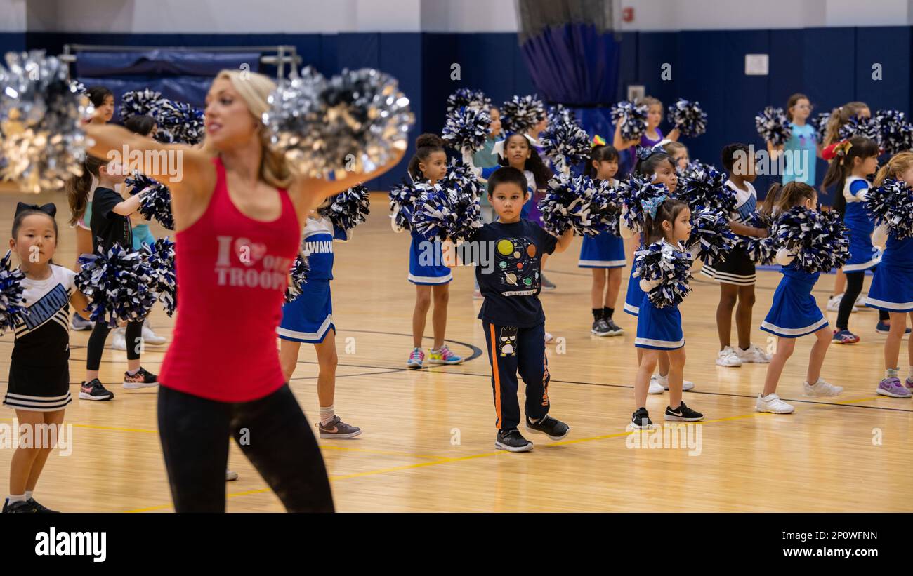 Marine Corps Air Station Iwakuni children perform a cheer routine with ...