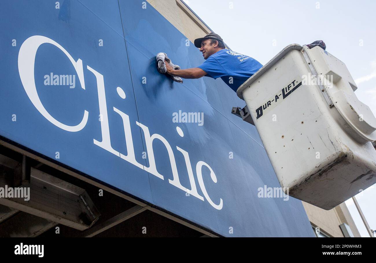 Muddy Feet Graphics sign installer Bill Bird puts the finishing touches ...
