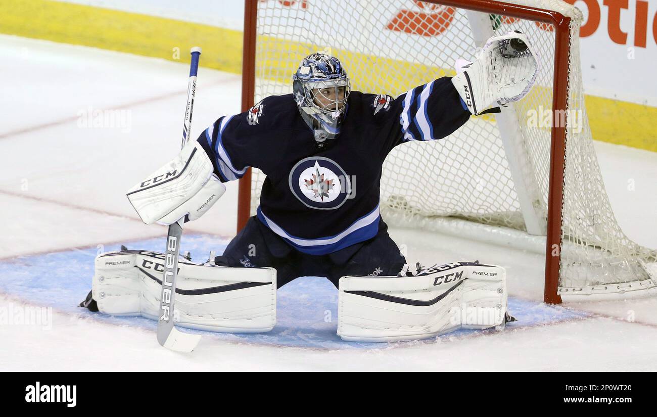 Winnipeg Jets goaltender Eric Comrie makes a glove save against the ...