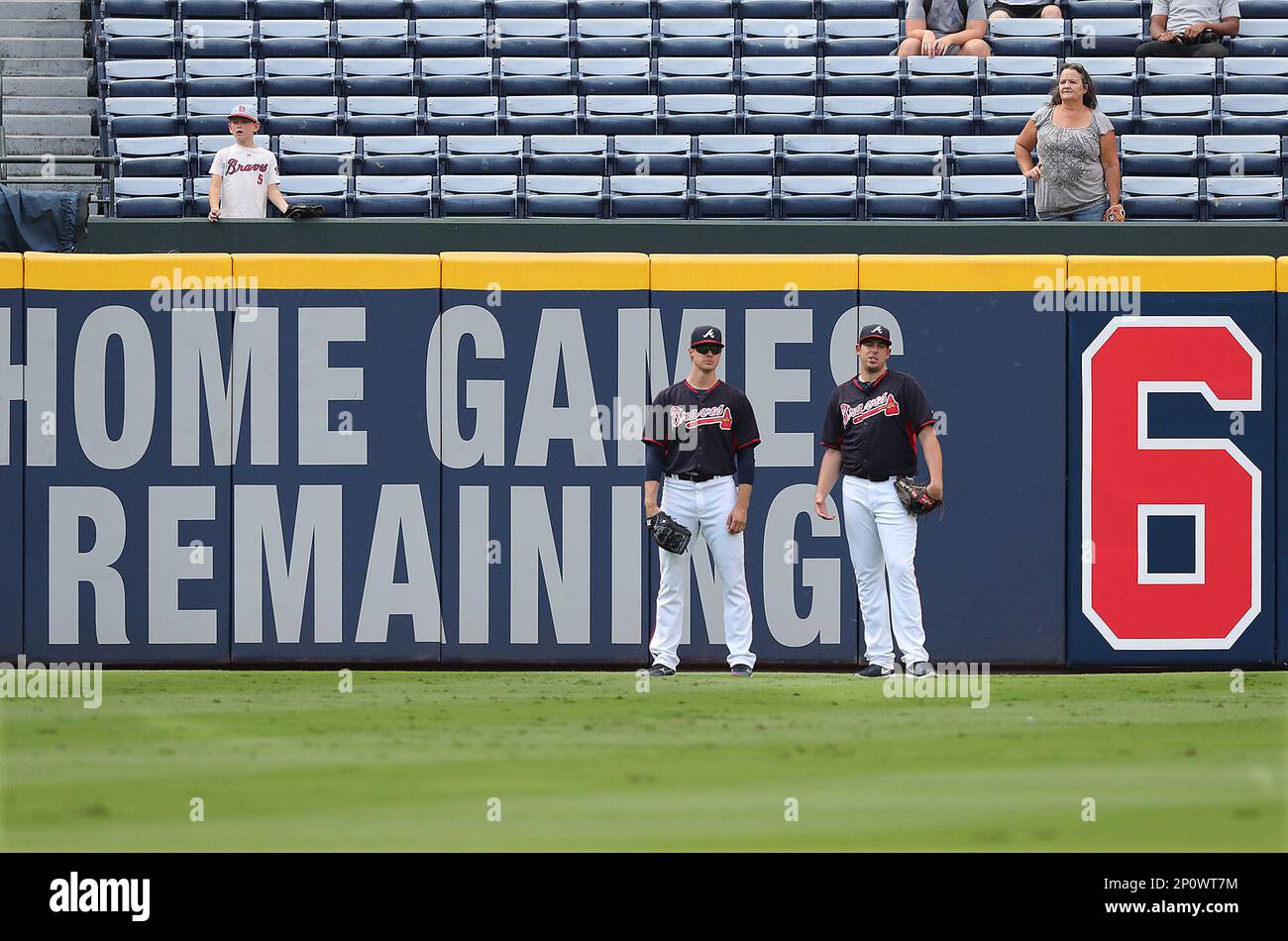 A Youngster Waits To Catch A Ball In The Outfield As The Atlanta Braves Prepare To Play The