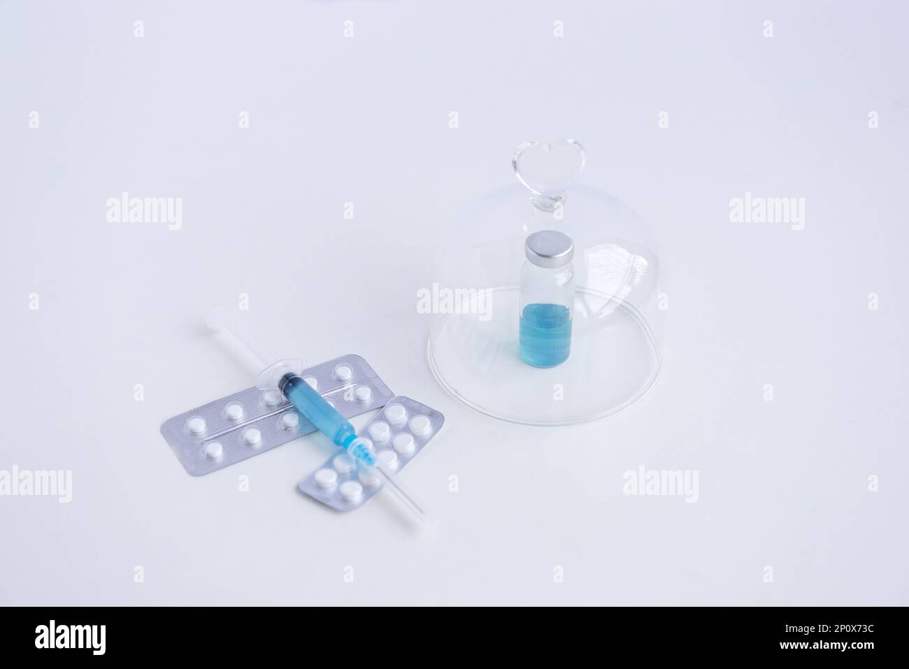 On white isolated background lie a syringe with medicine, a vial with a ...