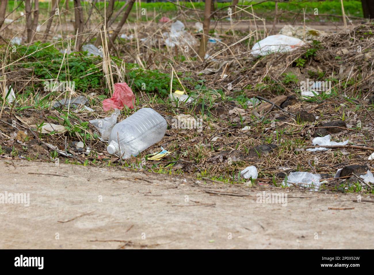 Spring forest stream river garbage waste plastic tire glass bottles after the snow melted ...
