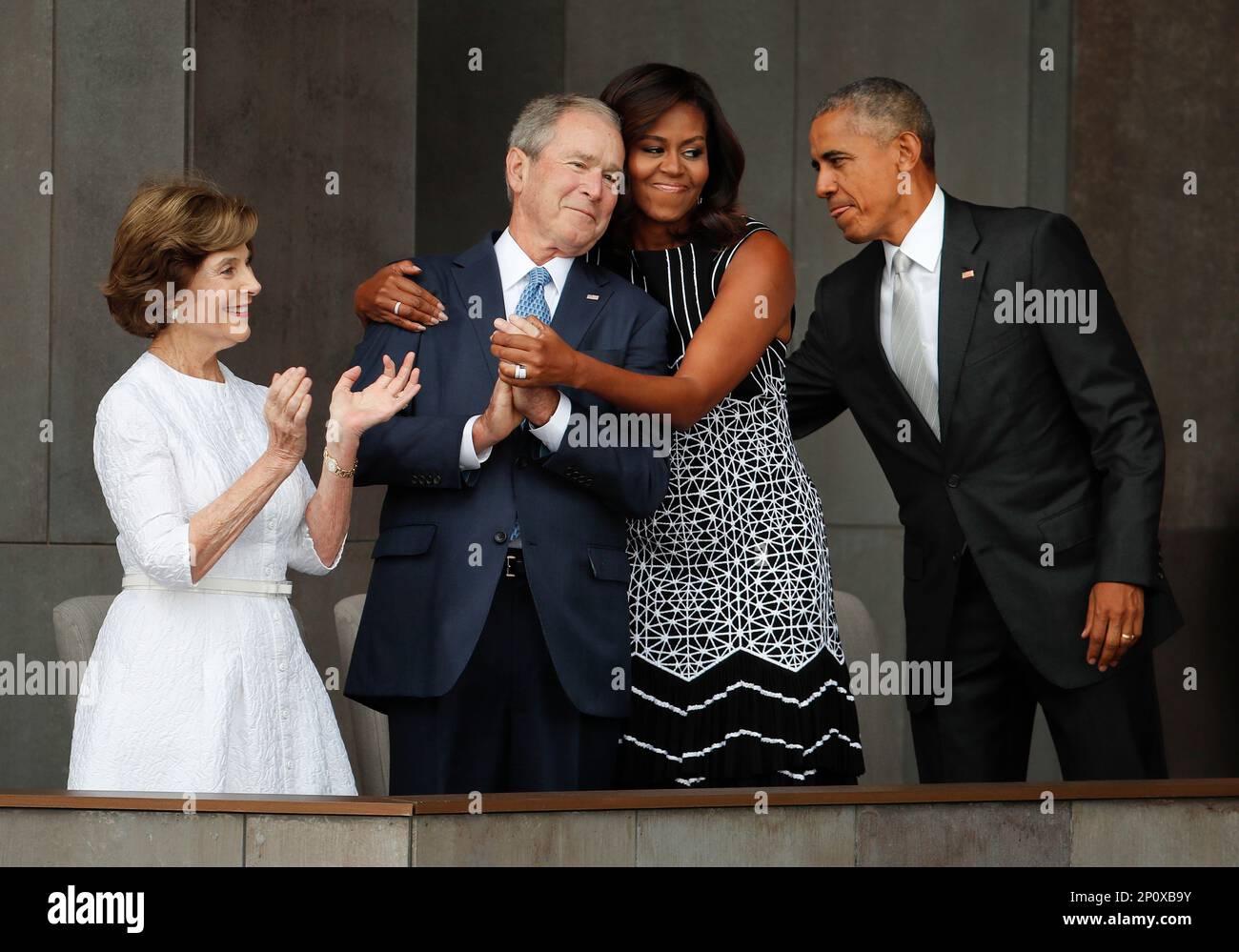 First lady Michelle Obama, center, hugs former President George W. Bush ...