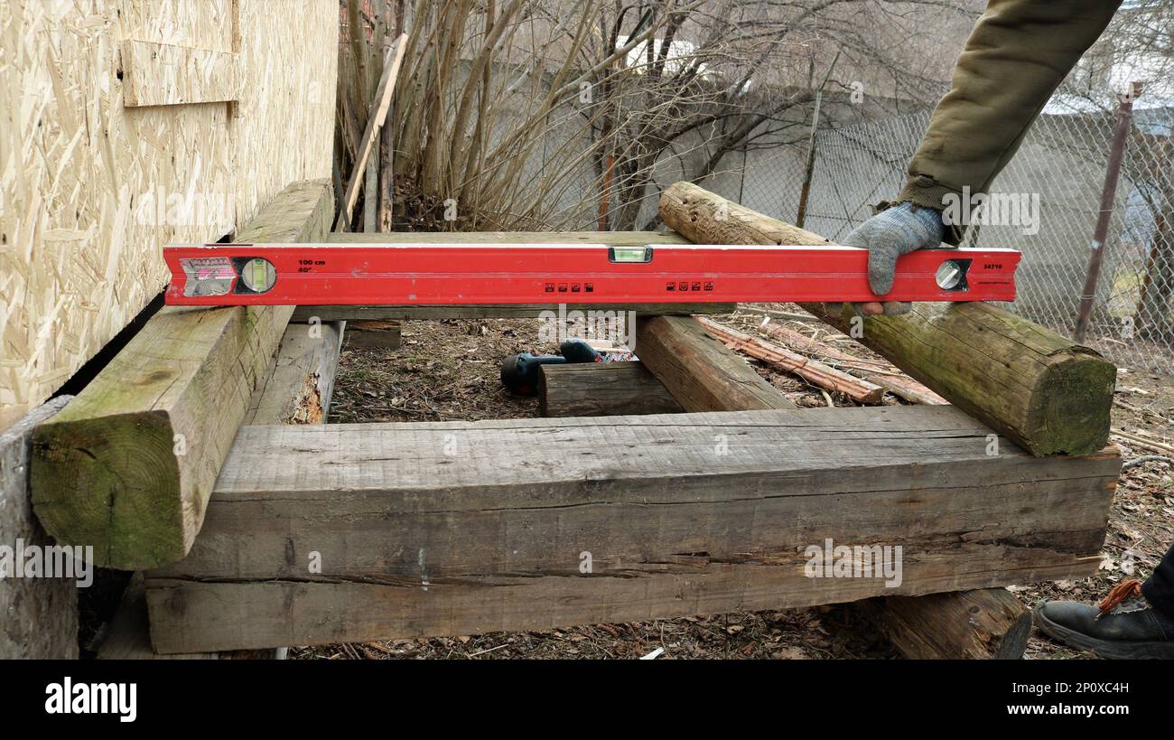 measuring the balance in a wooden structure with a level in red ...