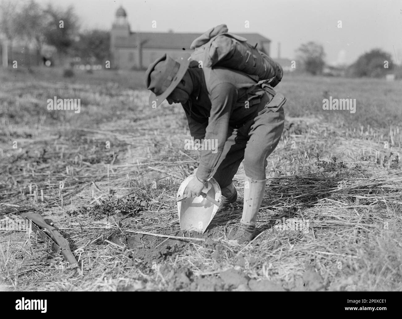 Leonard D. Mahon with steel helmet he invented that could be used as ...