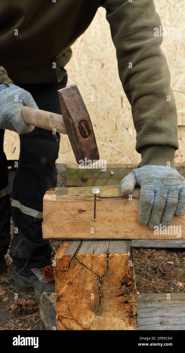 Handyman hammering nail in hi-res stock photography and images - Alamy