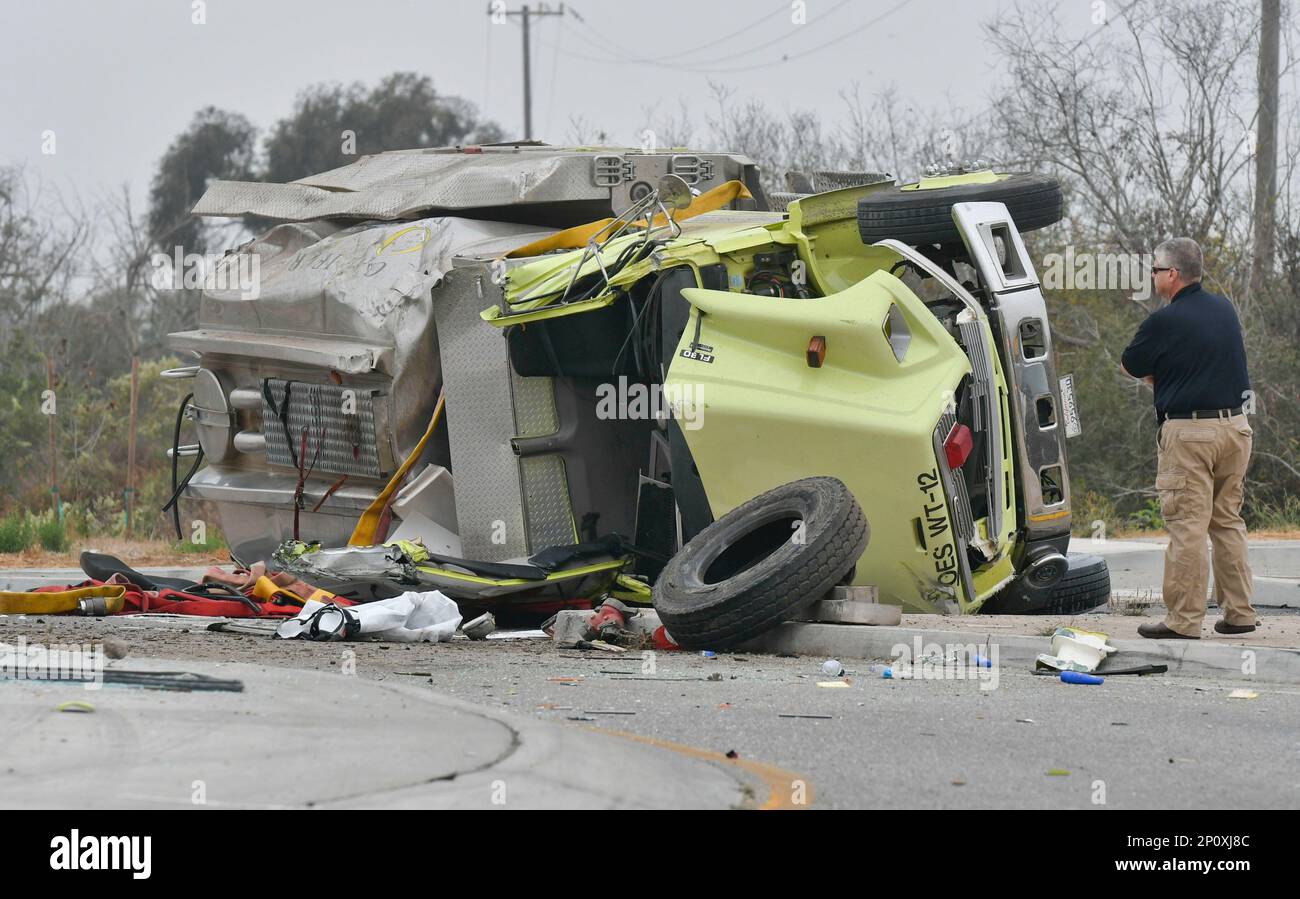 A California Highway Patrol investigator looks at the wreck of a water ...