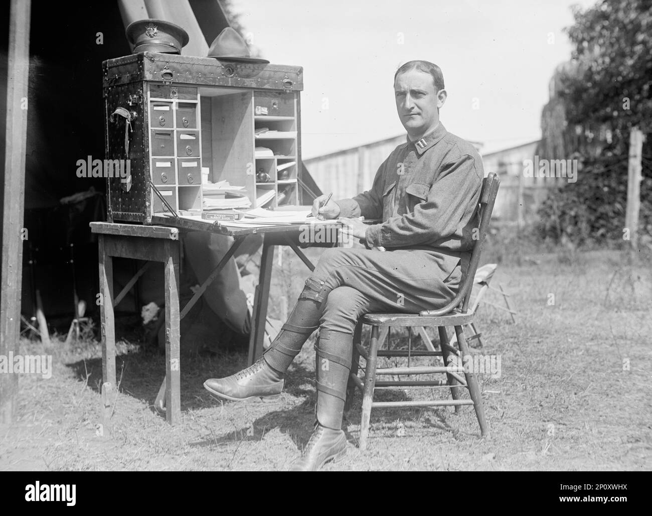 National Guard of D.C. - Capt. Louis Wilson, 1916. Sitting at writing ...