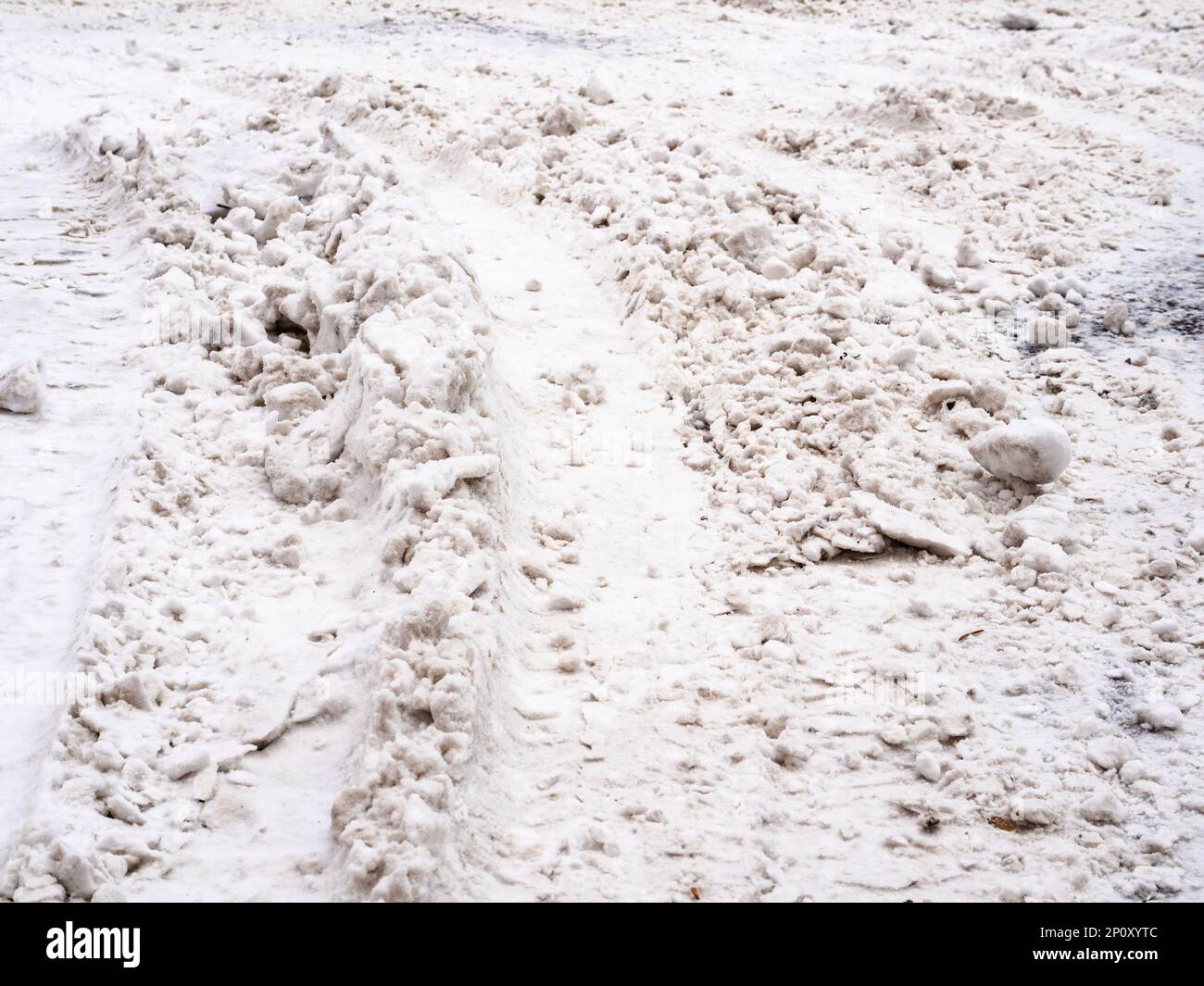 snow-covered ruts on surface of urban road in winter Stock Photo - Alamy