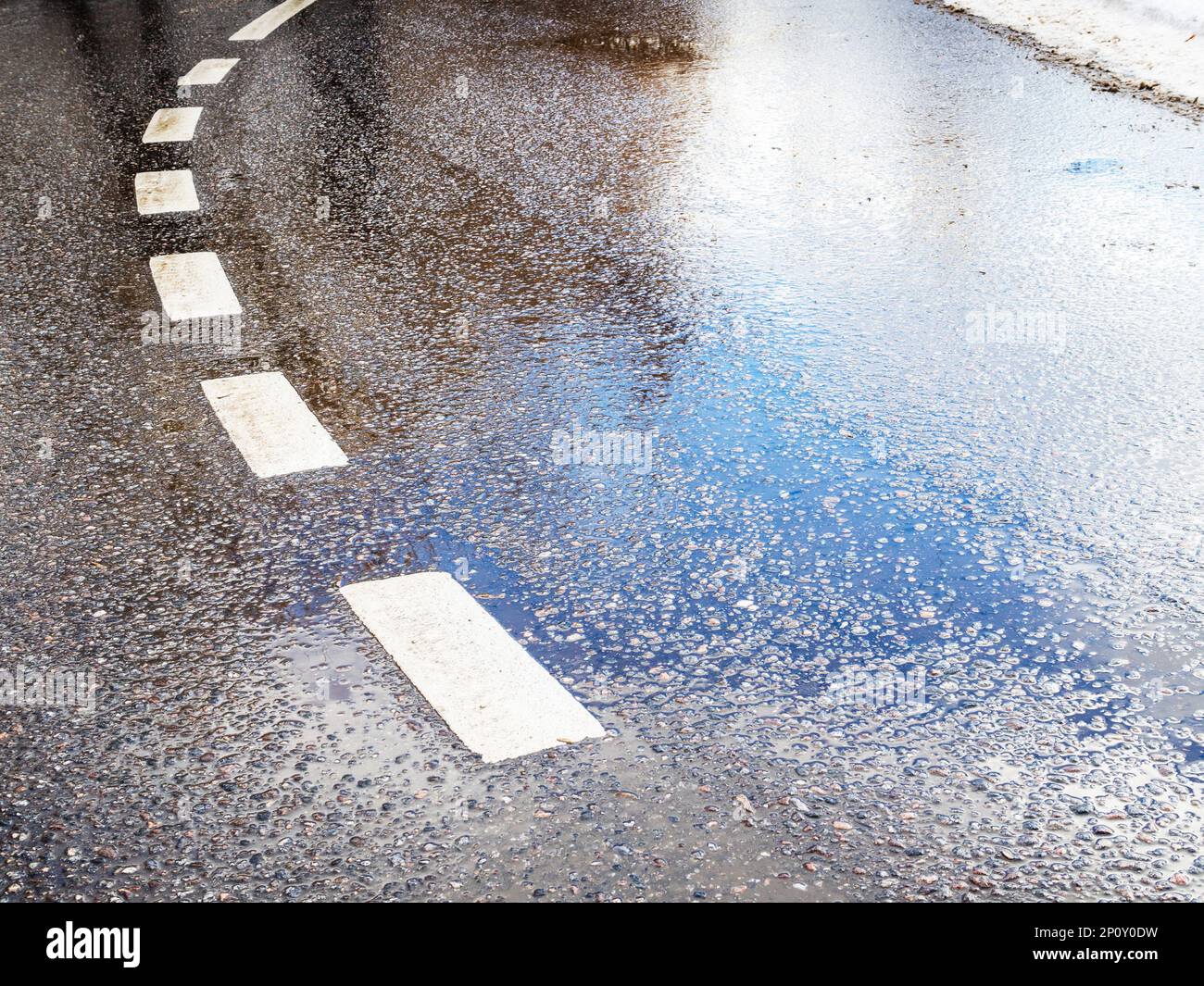 slippery and wet from melting snow surface of urban asphalt road Stock ...