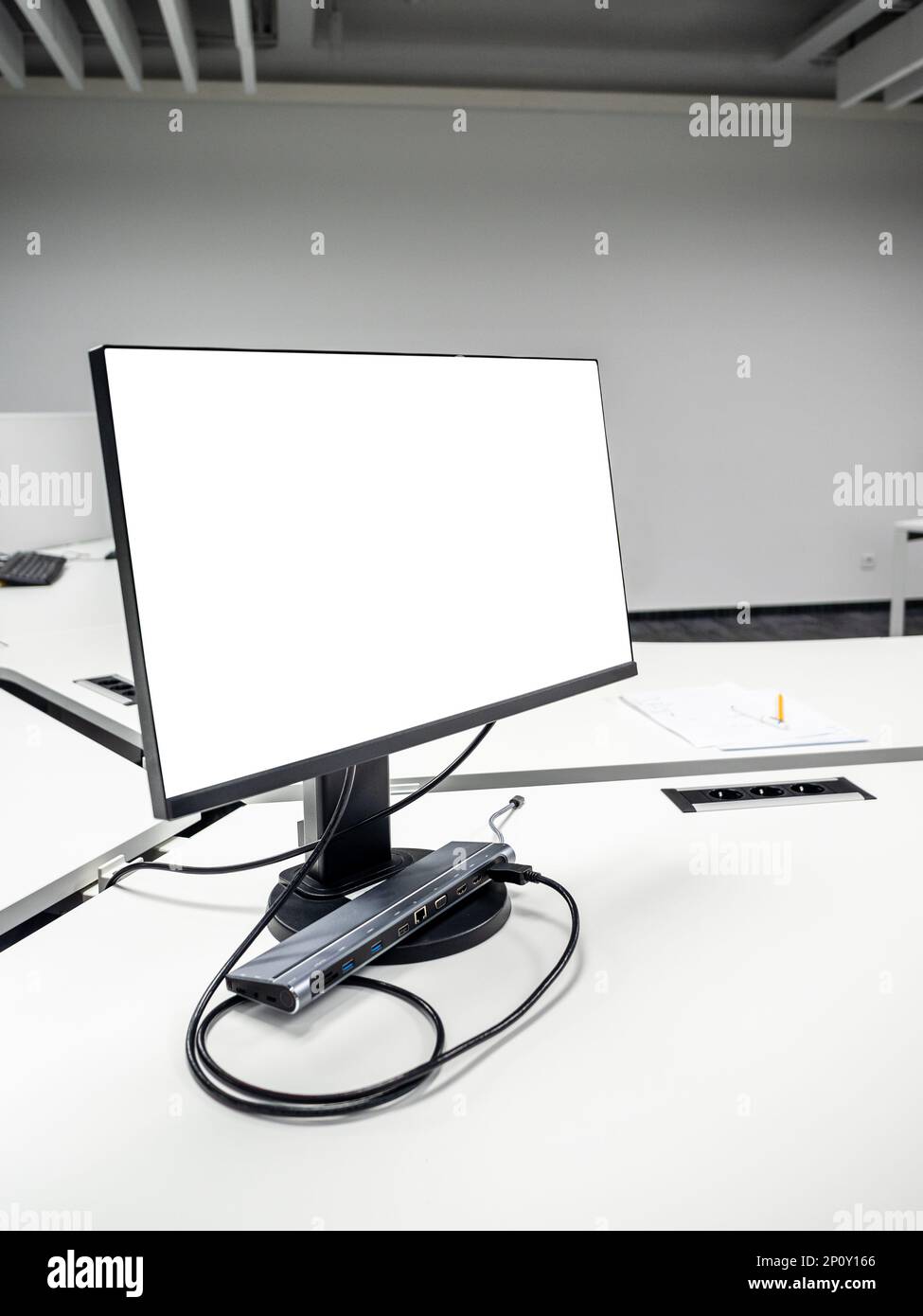 computer monitor with cutout screen on white table in empty office ...