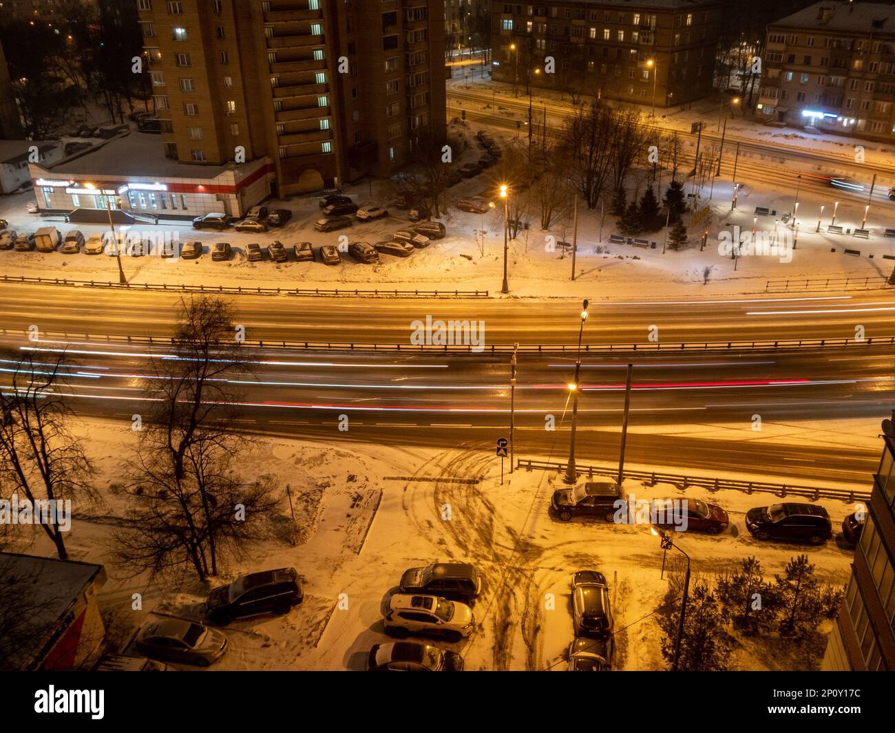 above view of light from passing cars over city road in residential ...