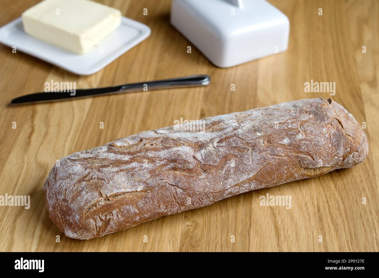 Crispy ciabatta, butter on white butter dish . Fresh bread, fried crust ...