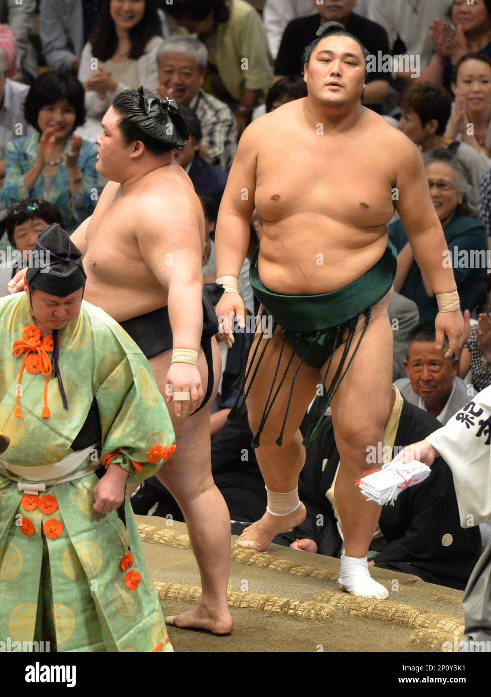 Unbeaten top maegashira Okinoumi (R) is pushed out by ozeki Goeido (R ...