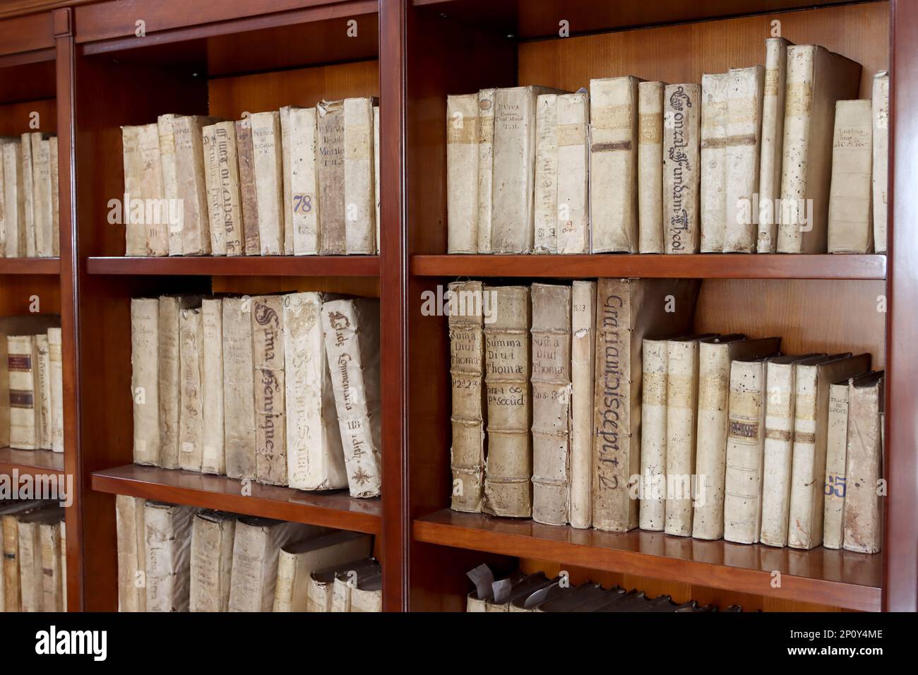 Library shelves with ancient religious books from the 1500s. High ...