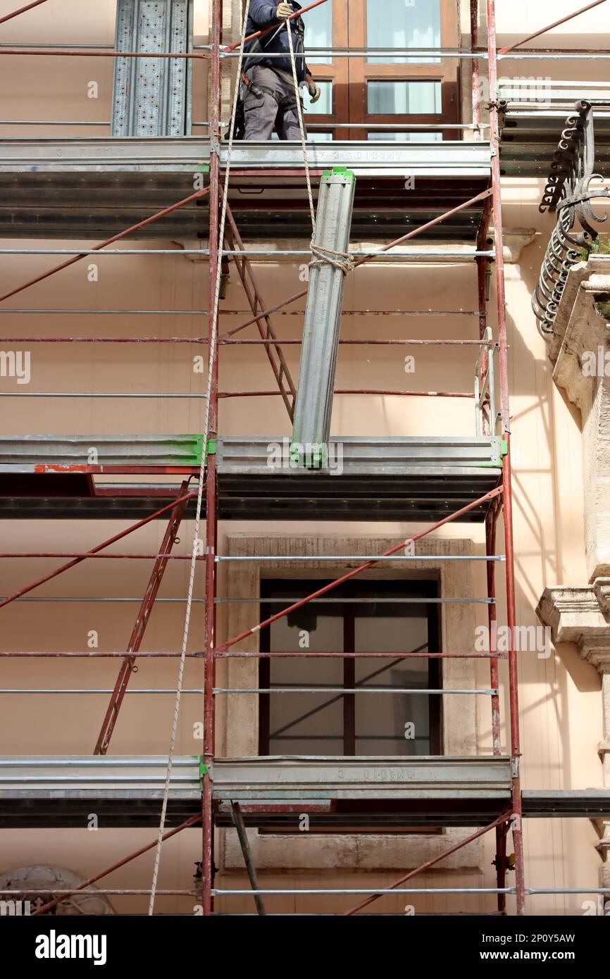 Scaffolding for building renovation work on a building facade. High ...