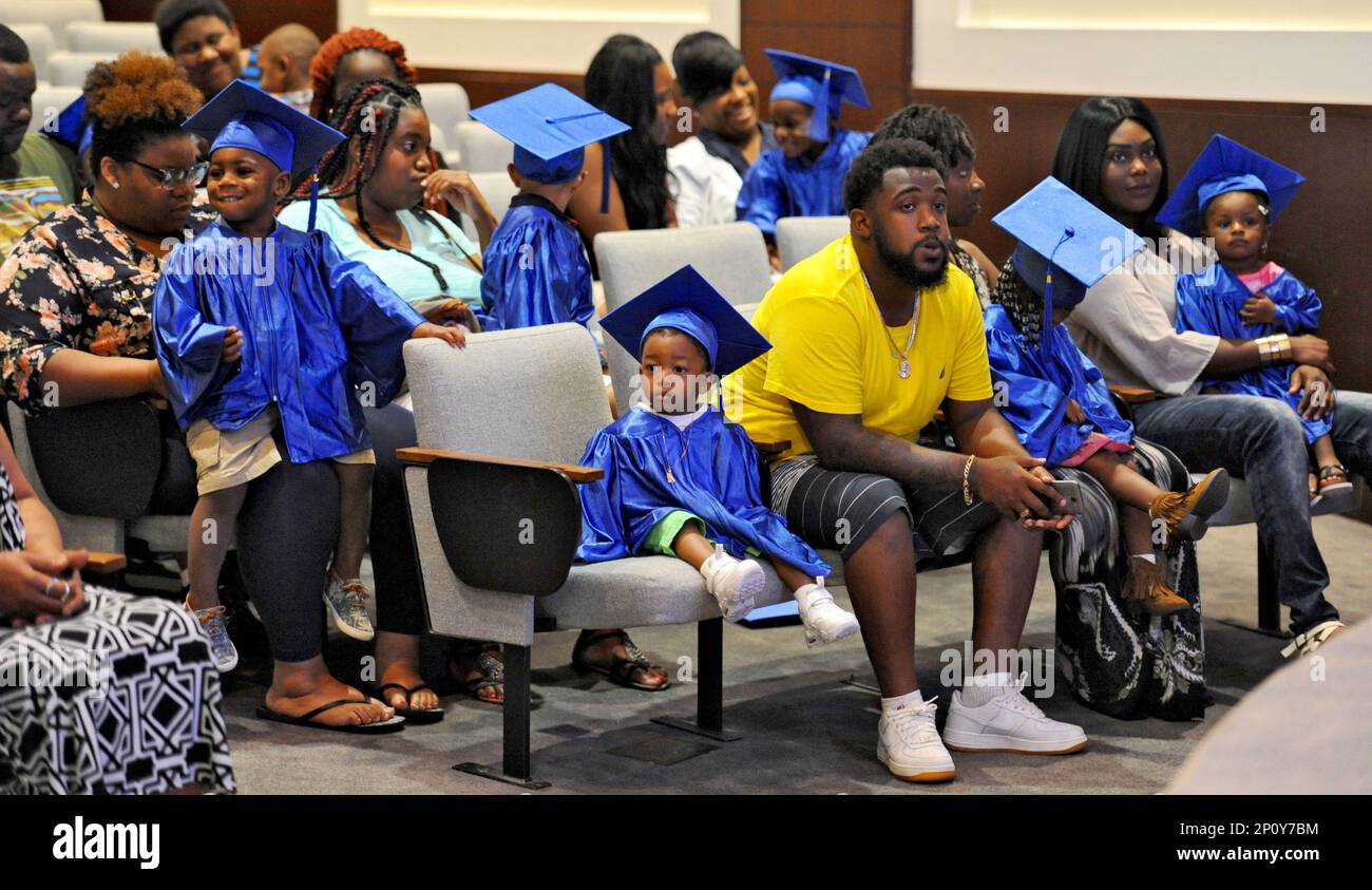 The graduates and their parents, including Jaylin Brooks sitting on his ...