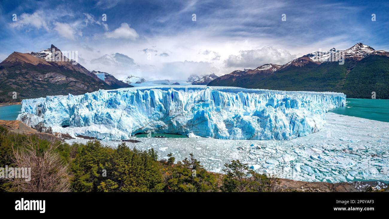 A scenic landscape featuring a large, majestic glacier situated in the ...