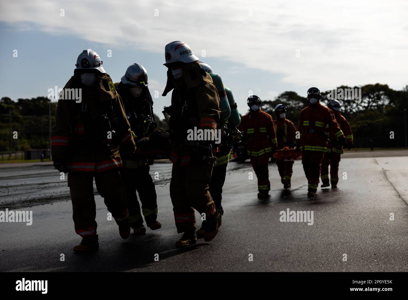 Firefighters with the Kinchiku Fire Department and the Motobu Town ...