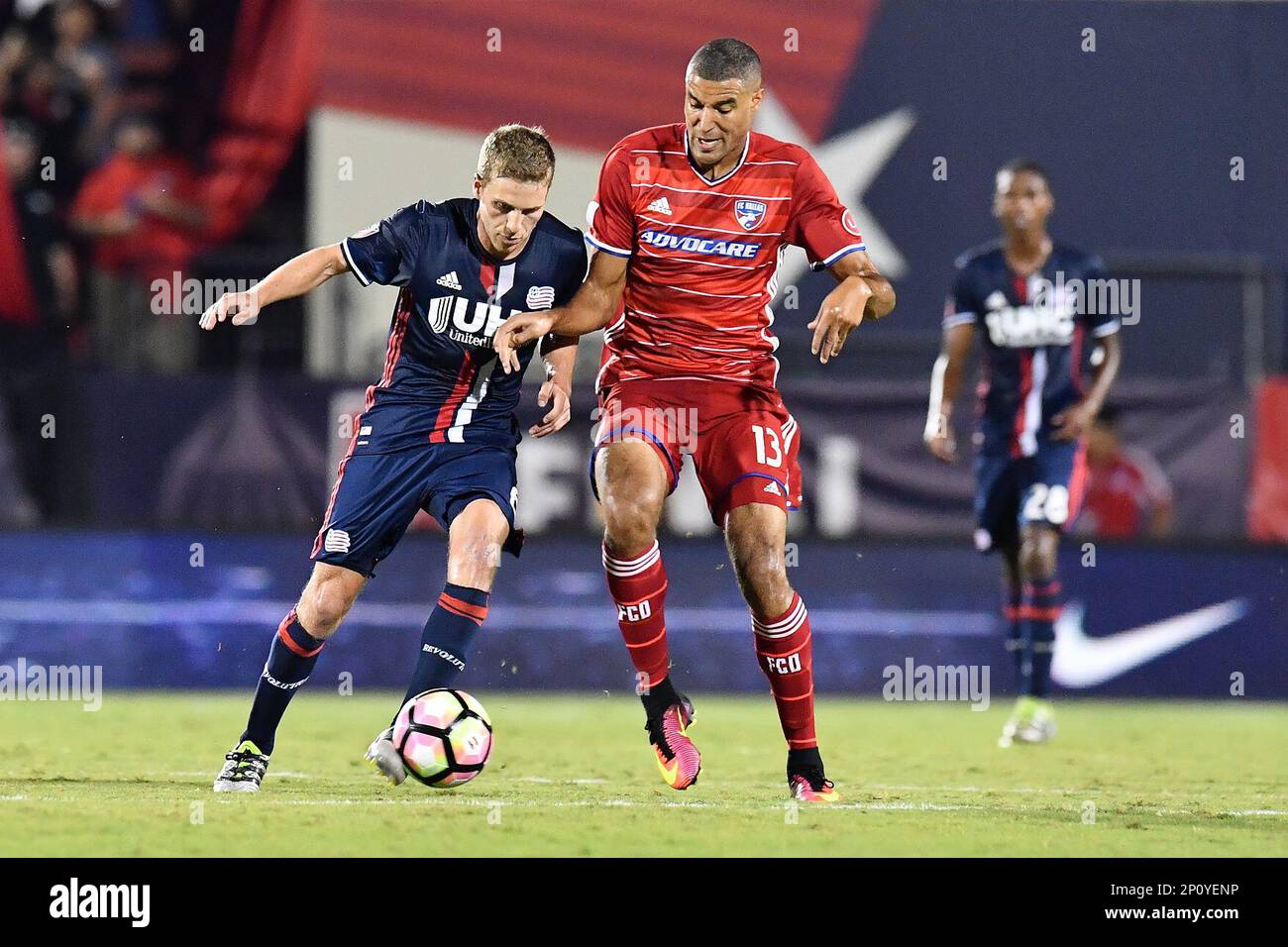 New England midfielder Scott Caldwell (6) and FC Dallas forward Tesho ...