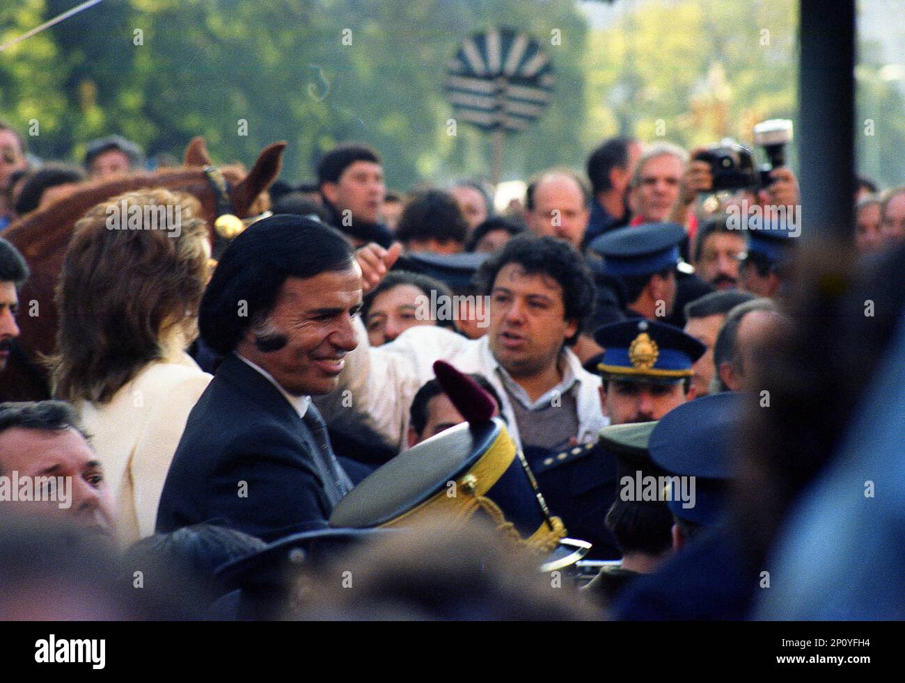 Carlos Saúl Menem greets supporters in a motorcade approaching Casa ...