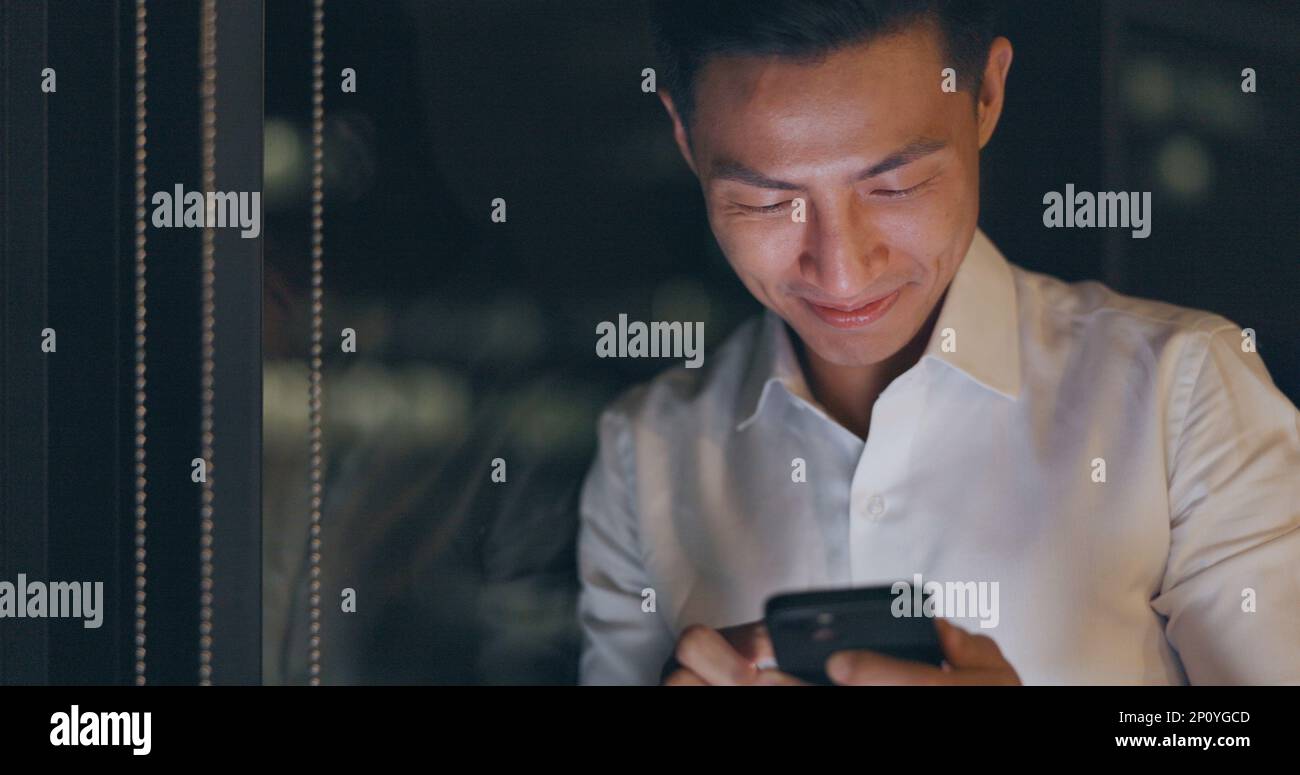 Smartphone, night and business man networking on global app, happy ...