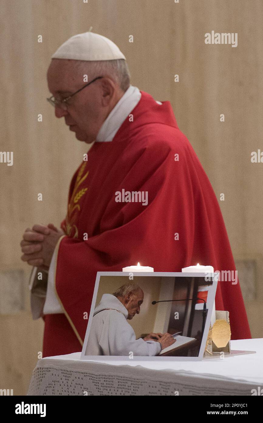 Pope Francis walks past a picture of Rev. Jacques Hamel as he ...