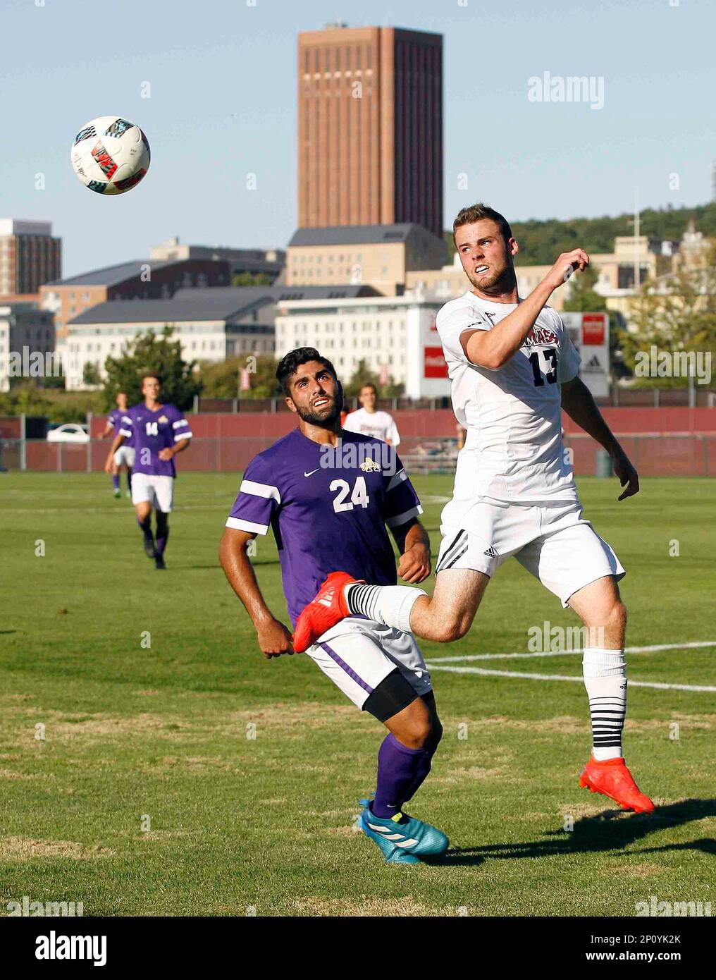 Massachusetts' Casey Hamill, right, heads the ball away from Albany's ...