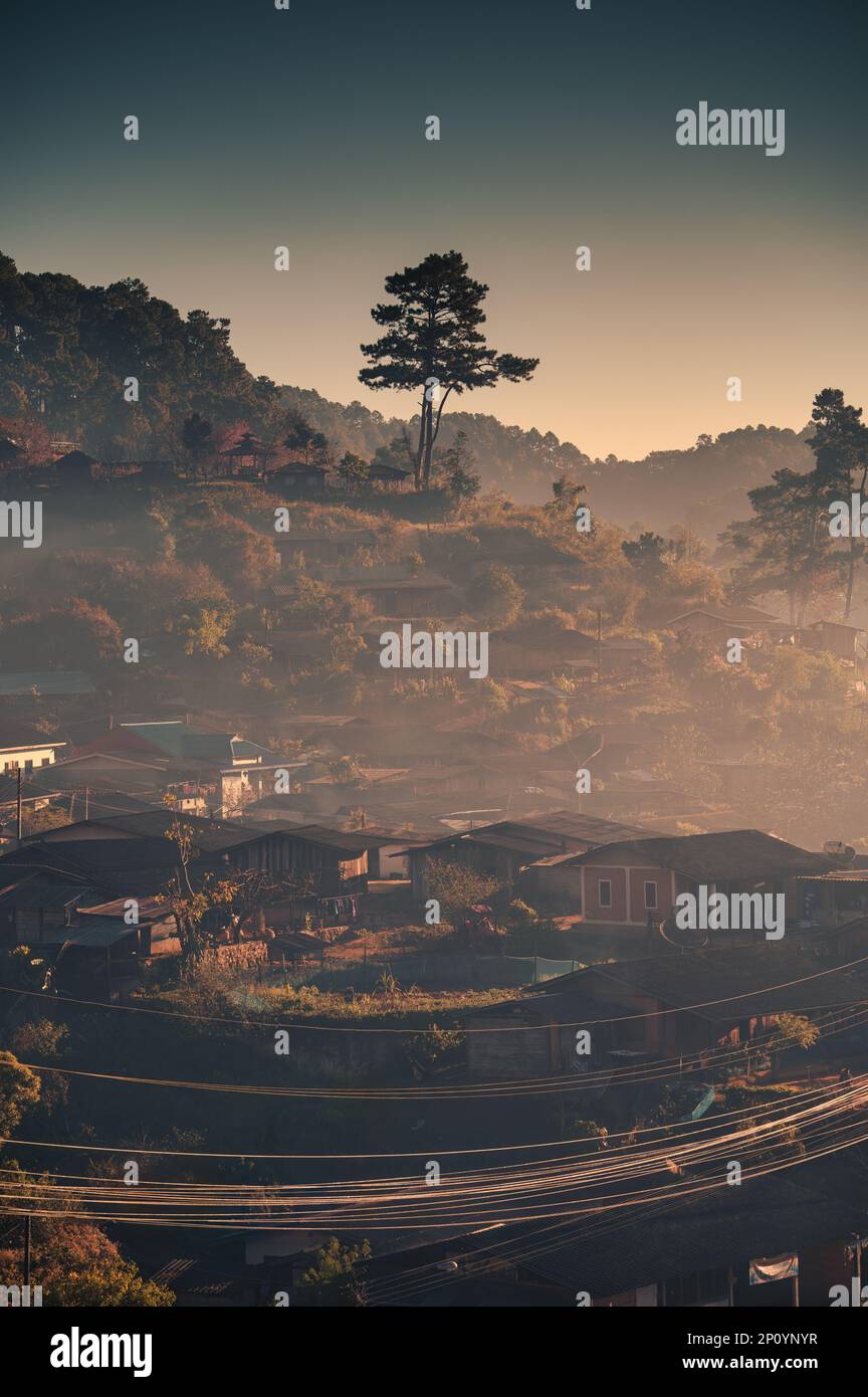 Traditional tribe village with tree on hill in the foggy at the morning ...