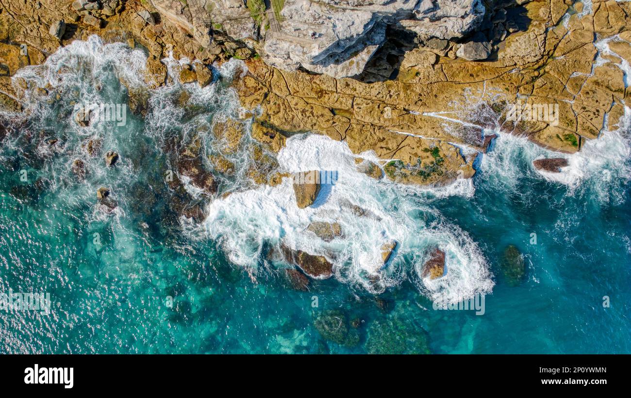 An aerial view of a majestic rock formation overlooking a tranquil body ...