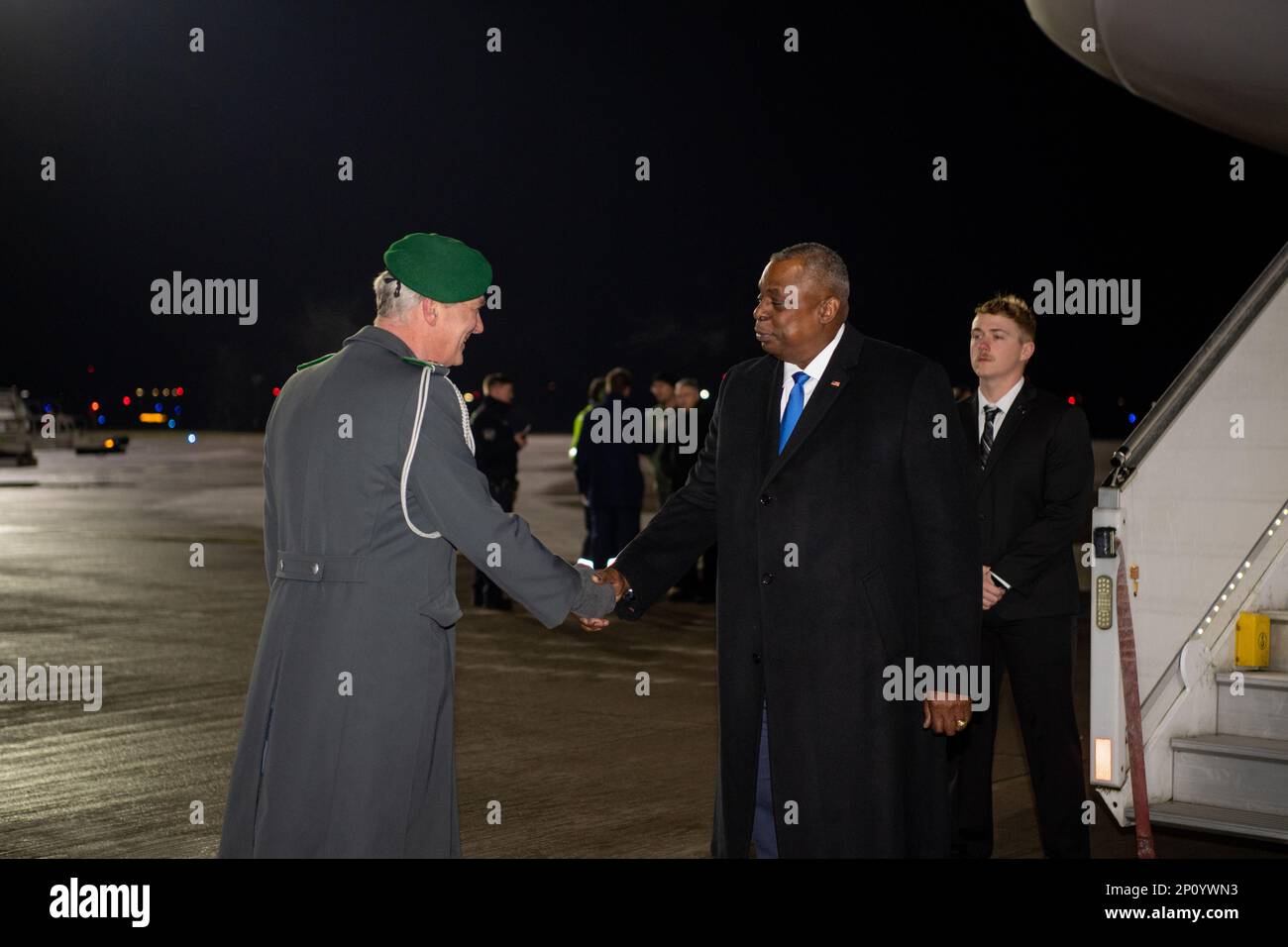 Secretary of Defense Lloyd J. Austin III is greeted by Ambassador Amy ...