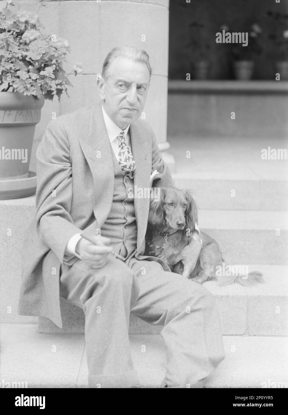 Alanson, Bertram, Mr., with dog, seated on steps, 1927 Stock Photo - Alamy