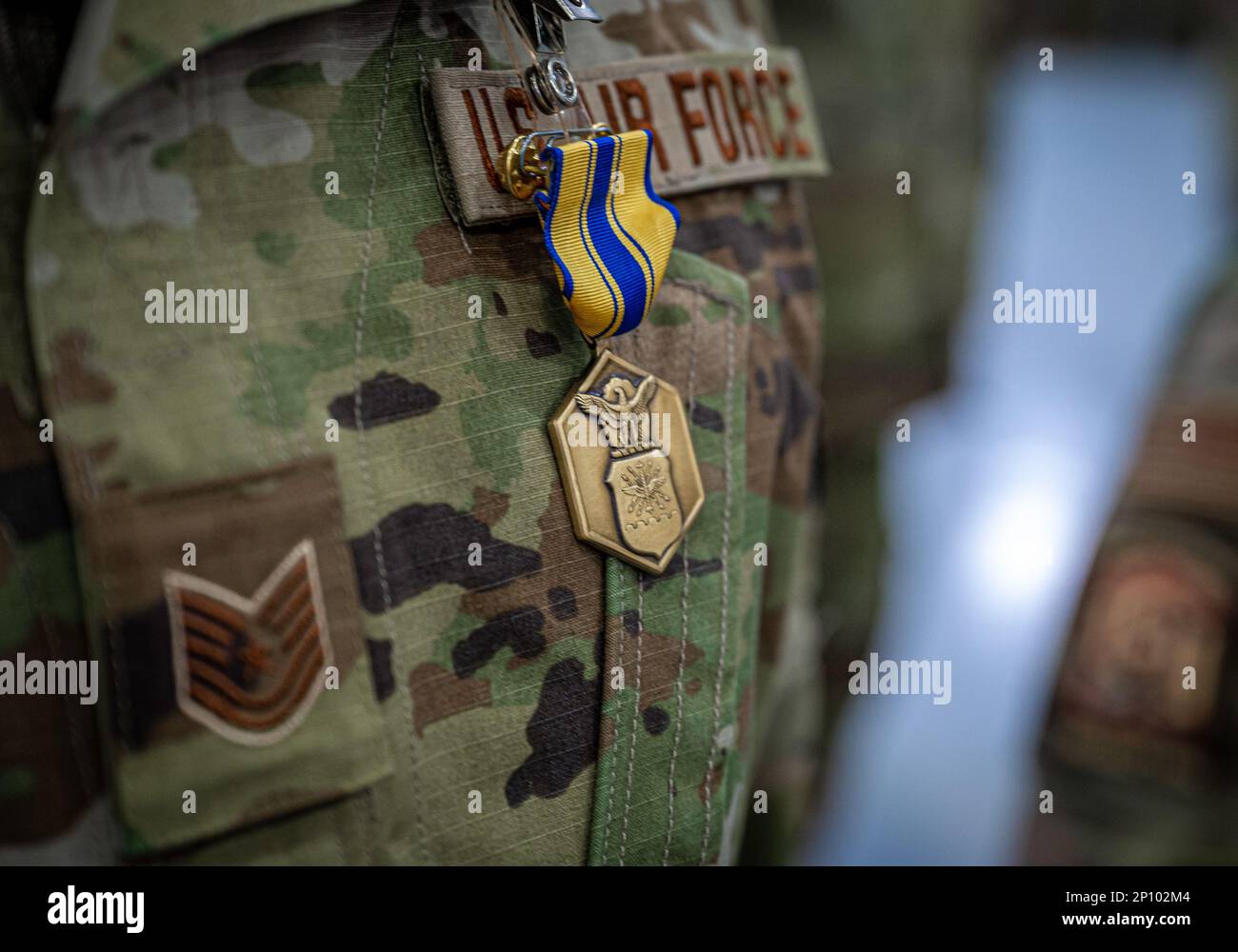 An Air Force Commendation Medal is pinned on the uniform of an airman ...