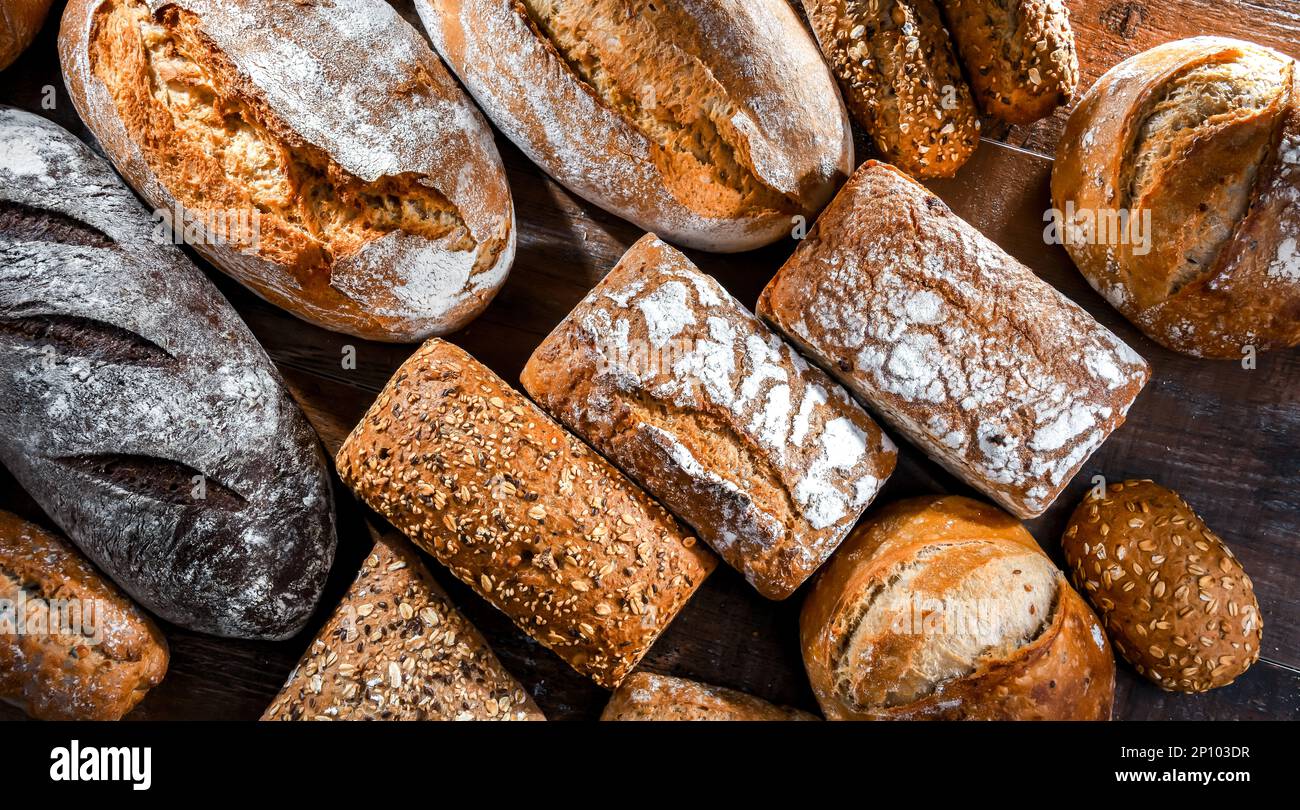 Assorted bakery products including loaves of bread and rolls Stock ...