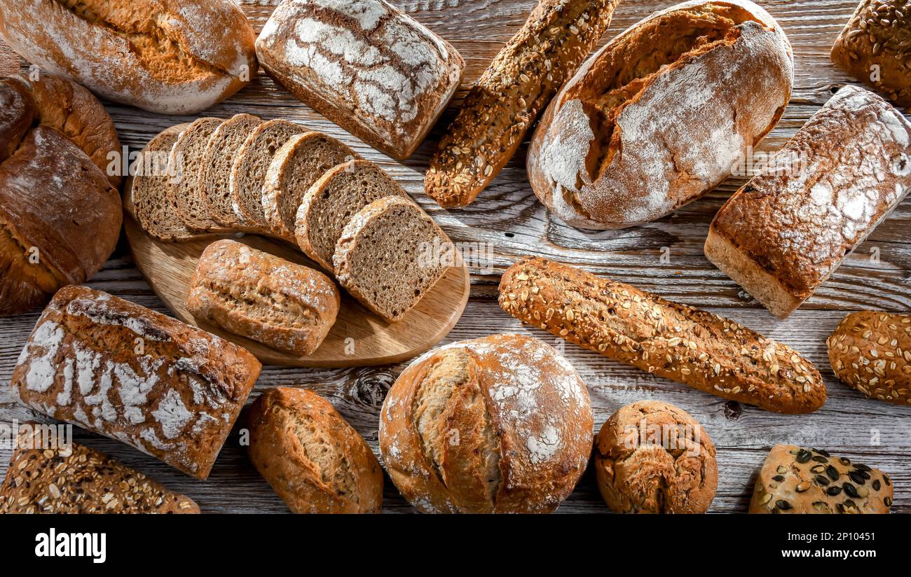 Assorted bakery products including loaves of bread and rolls Stock ...