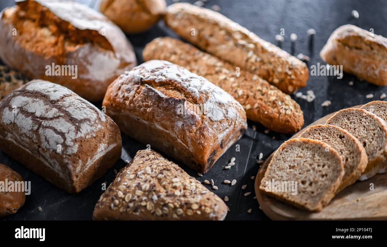Assorted bakery products including loaves of bread and rolls Stock ...
