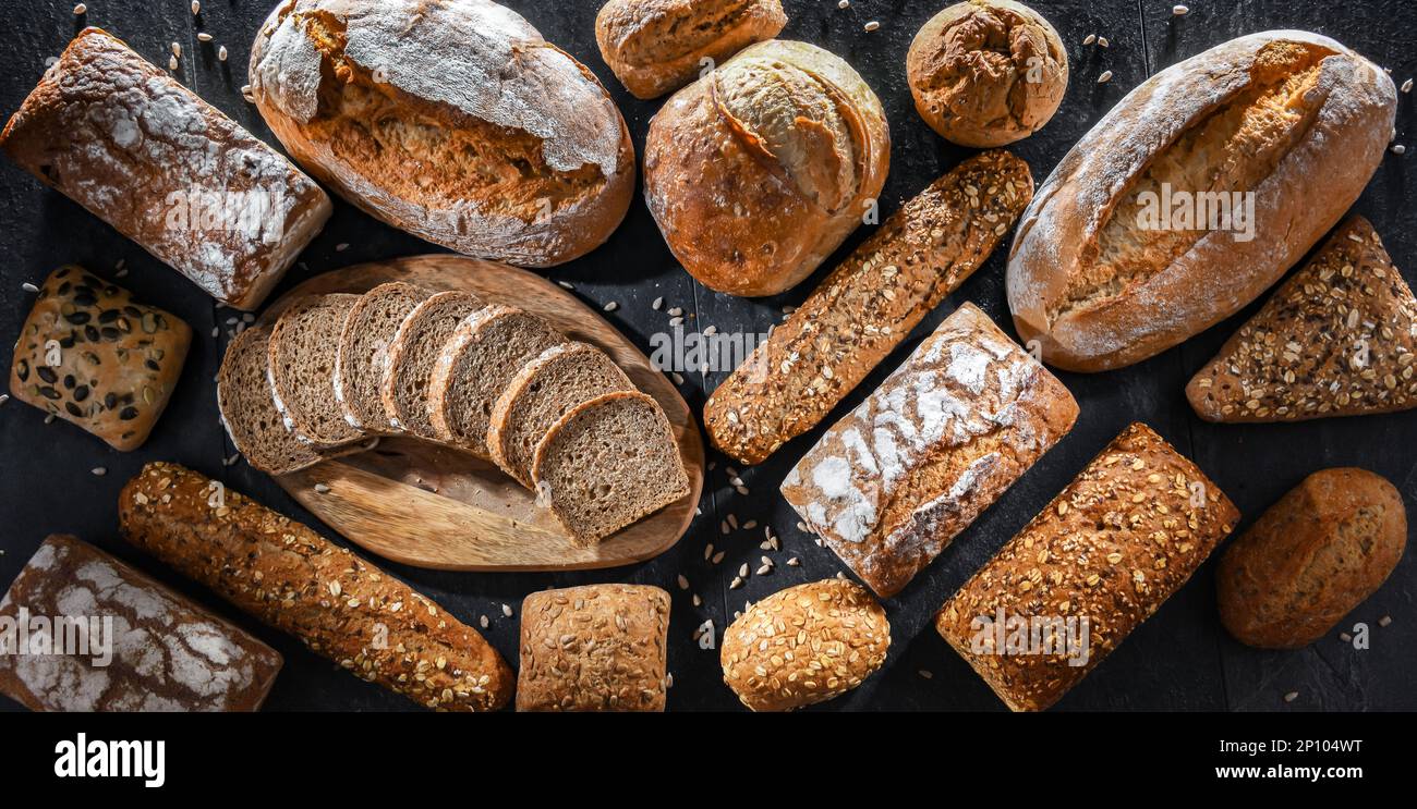 Assorted bakery products including loafs of bread and rolls Stock Photo ...