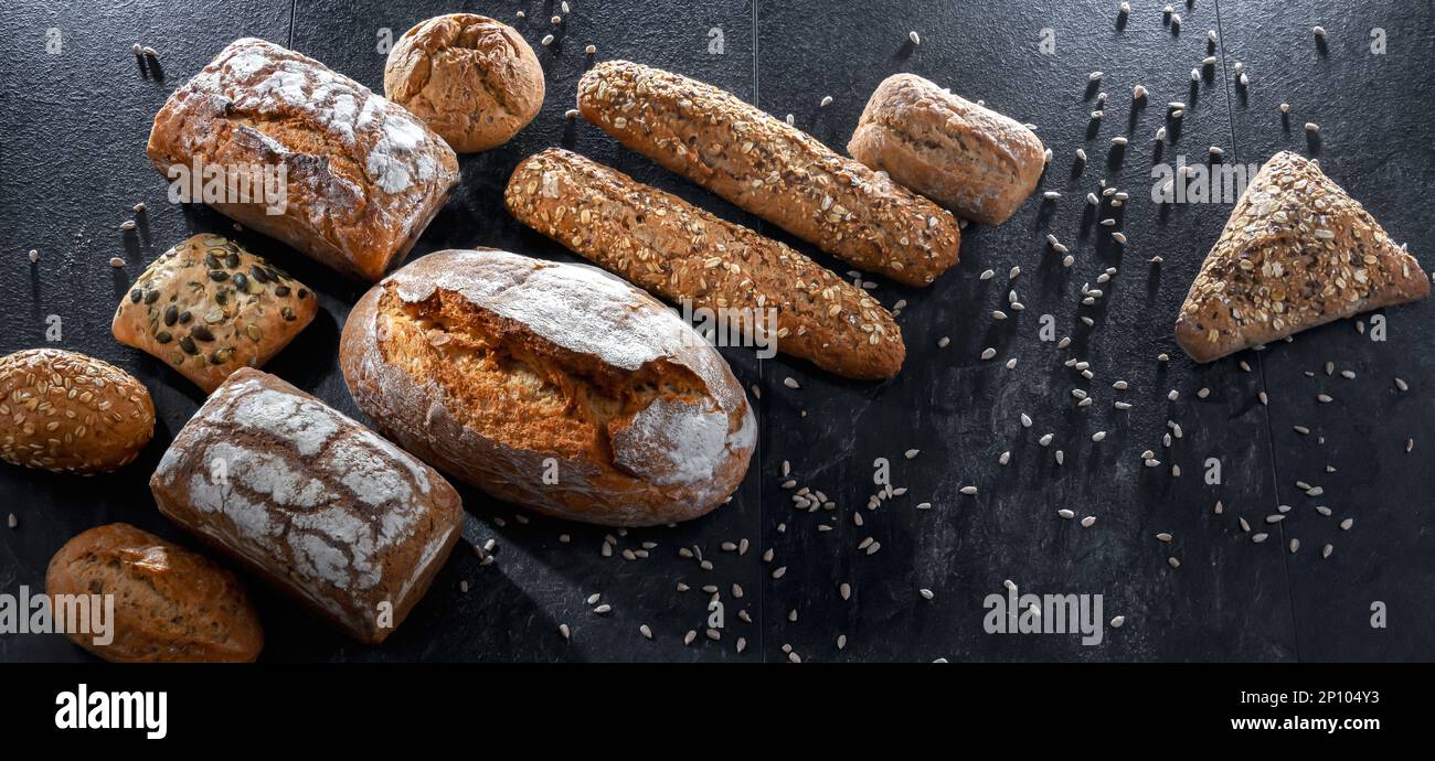 Assorted bakery products including loaves of bread and rolls Stock ...