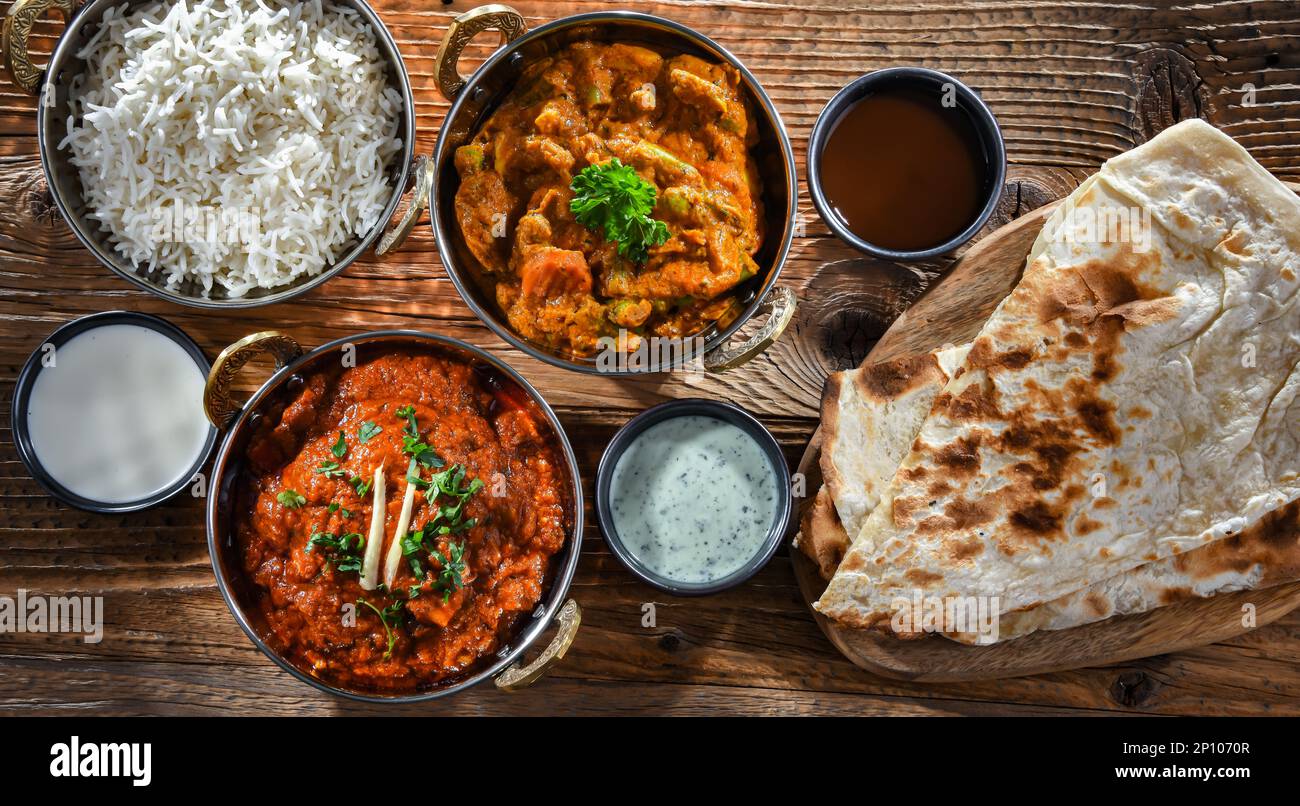 Hot madras paneer and vegetable masala with basmati rice served in ...