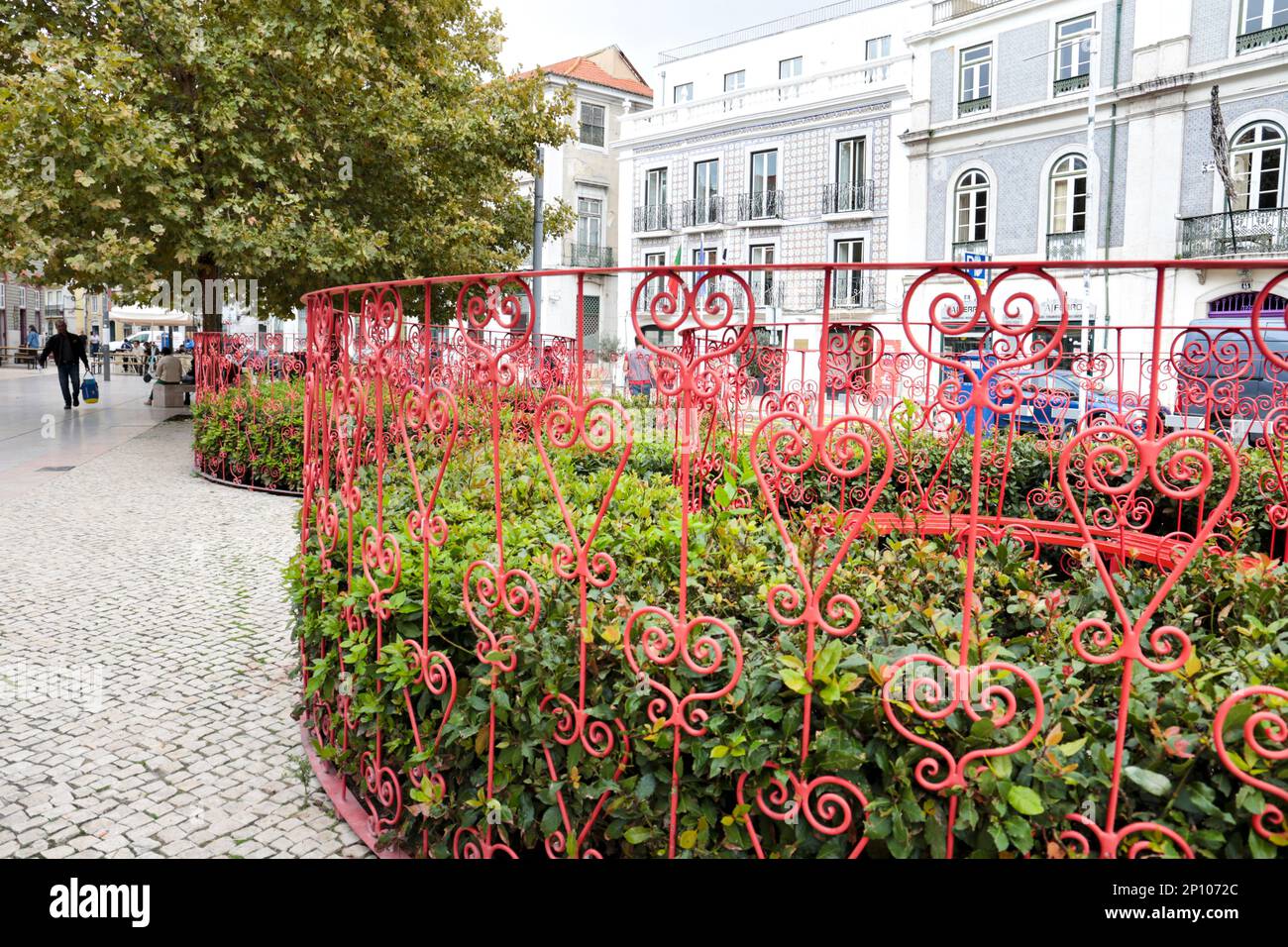 Metal forged fence painted red in a garden in Lisbon Square Stock Photo ...