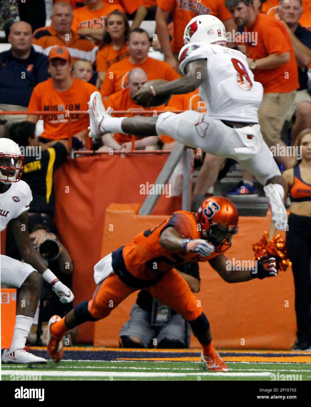 Louisville's Lamar Jackson jumps over Syracuse's Cordell Hudson and ...
