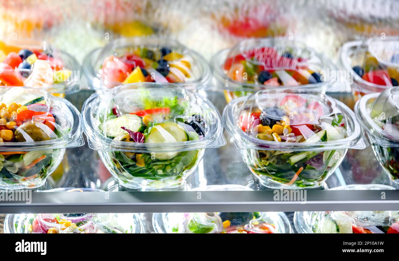 Plastic boxes with pre-packaged fruit and vegetable salads, put up for ...