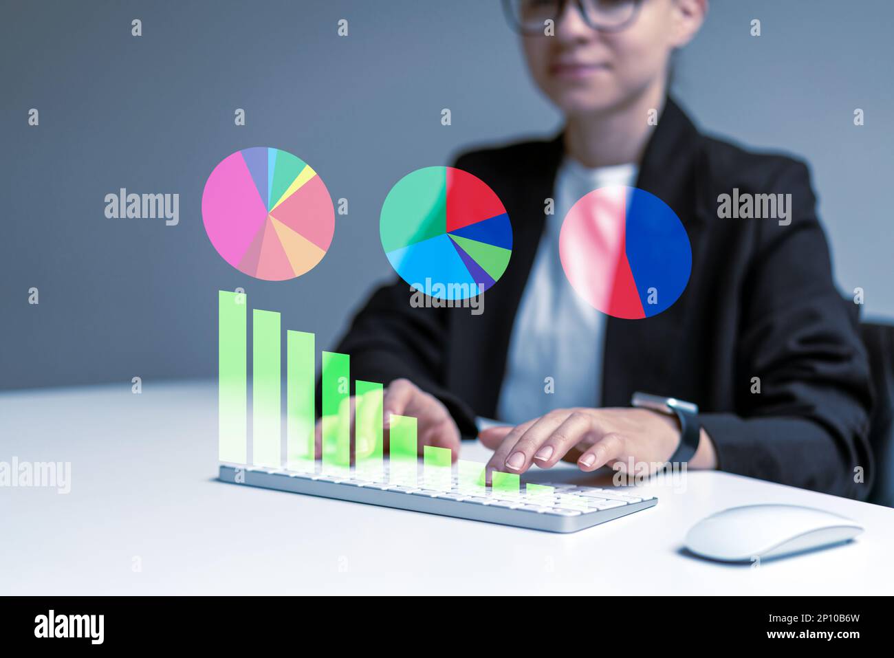 Woman business person working on computer looking at virtual chart and ...
