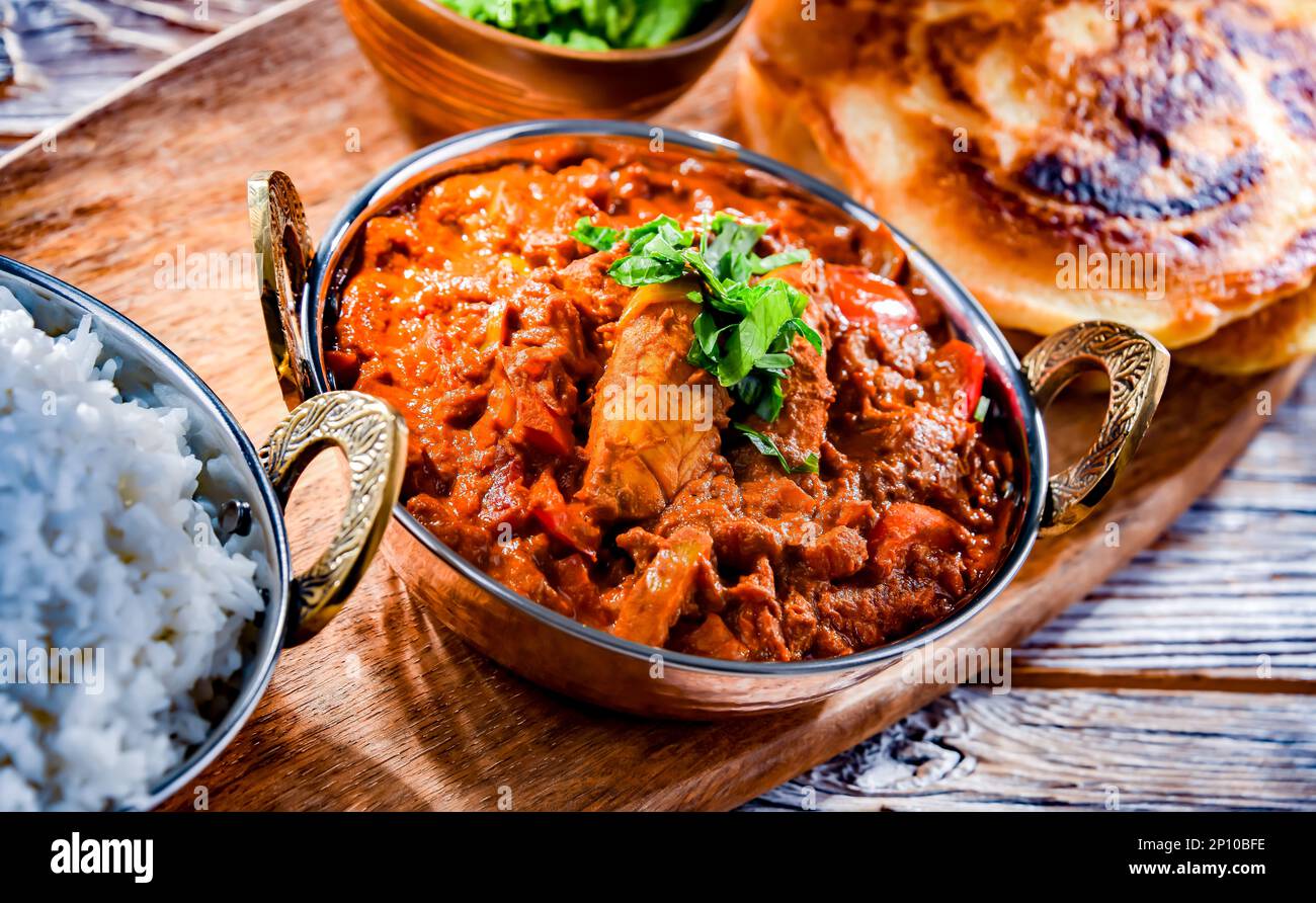Butter chicken with rice and naan flatbread served in original indian ...