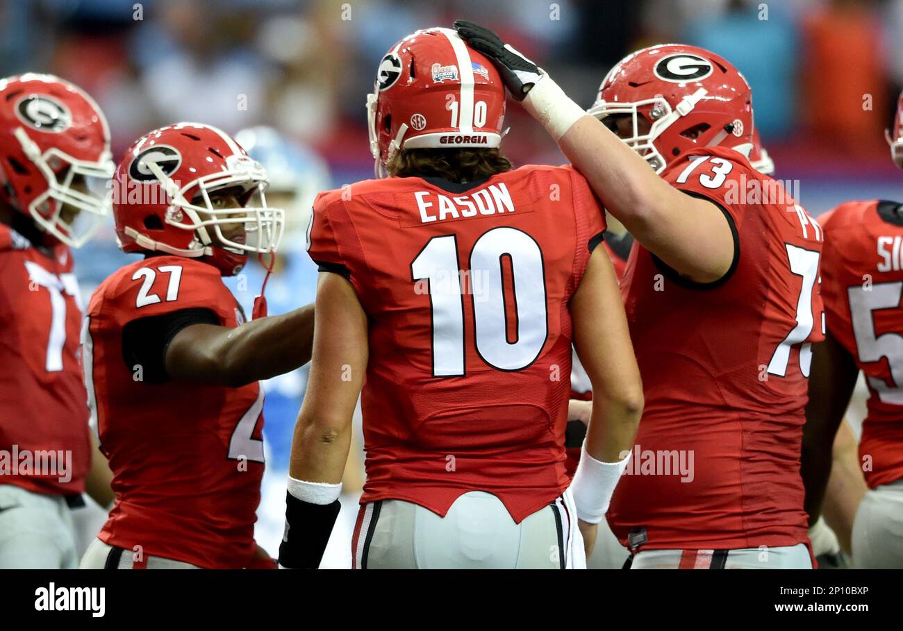 Georgia Bulldogs quarterback Jacob Eason (10) is welcomed to the huddle ...