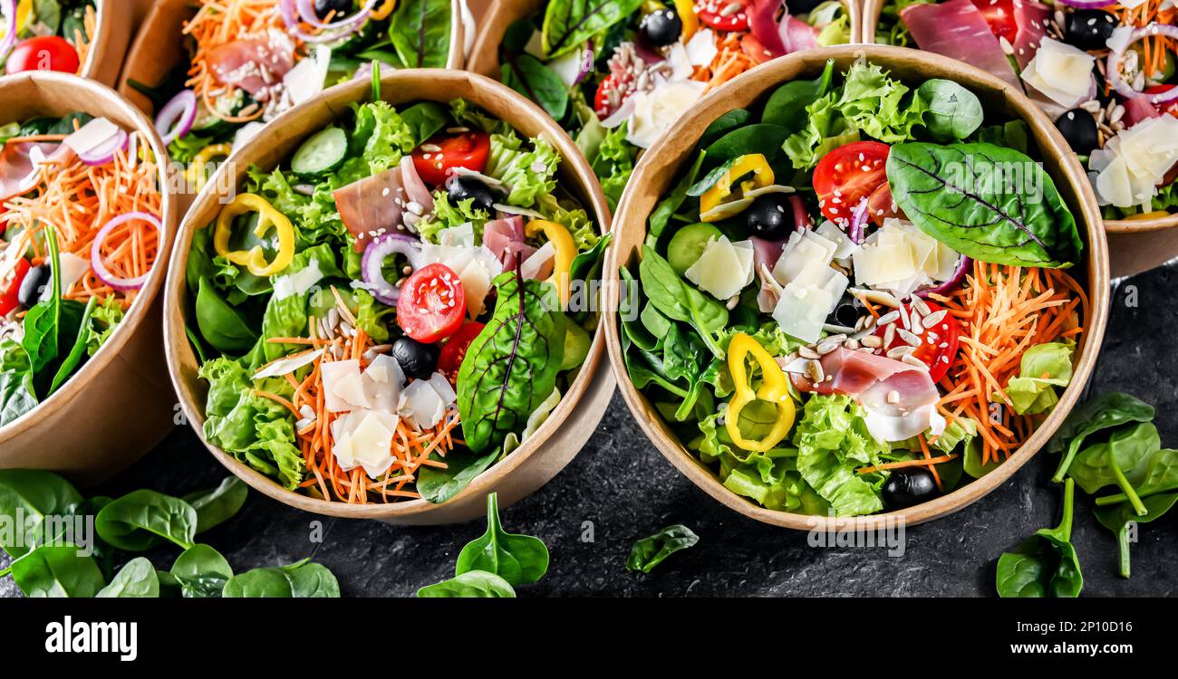 Round paper boxes with pre-packaged vegetable salads ready for sale ...